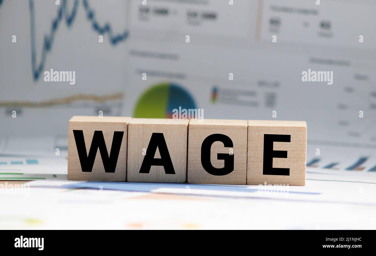 Wooden blocks with coins and the word Wage and up arrow. Increase of ...