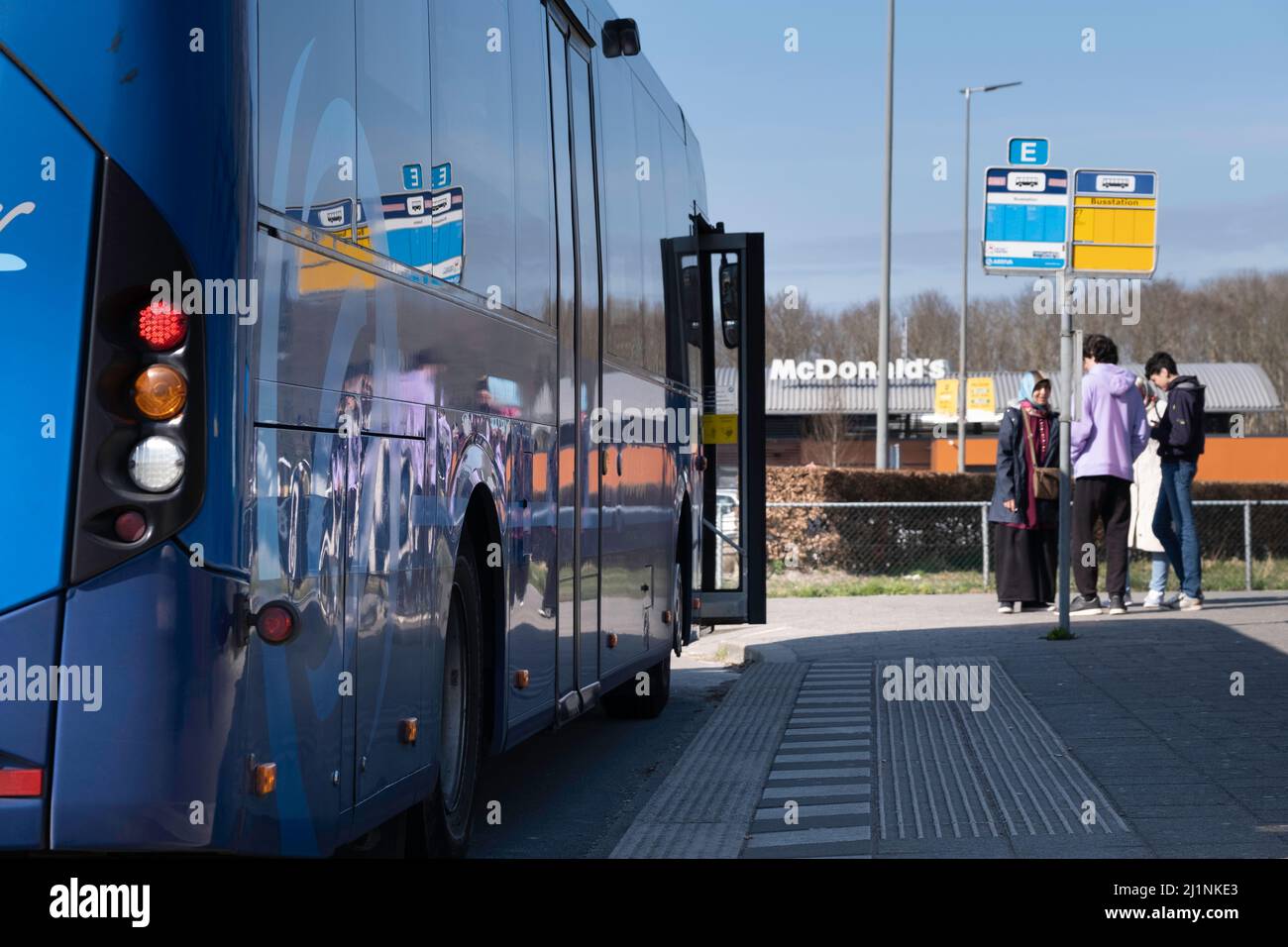 Blue Qliner bus with opened doors at the station of the Dutch village ...