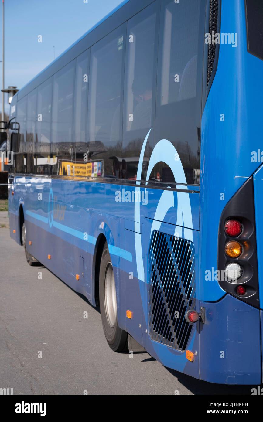Side view of a blue Qliner bus at the station of the dutch village of ...