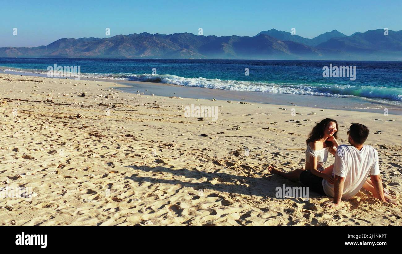 A romantic couple enjoying their time together on the beach on Gili ...