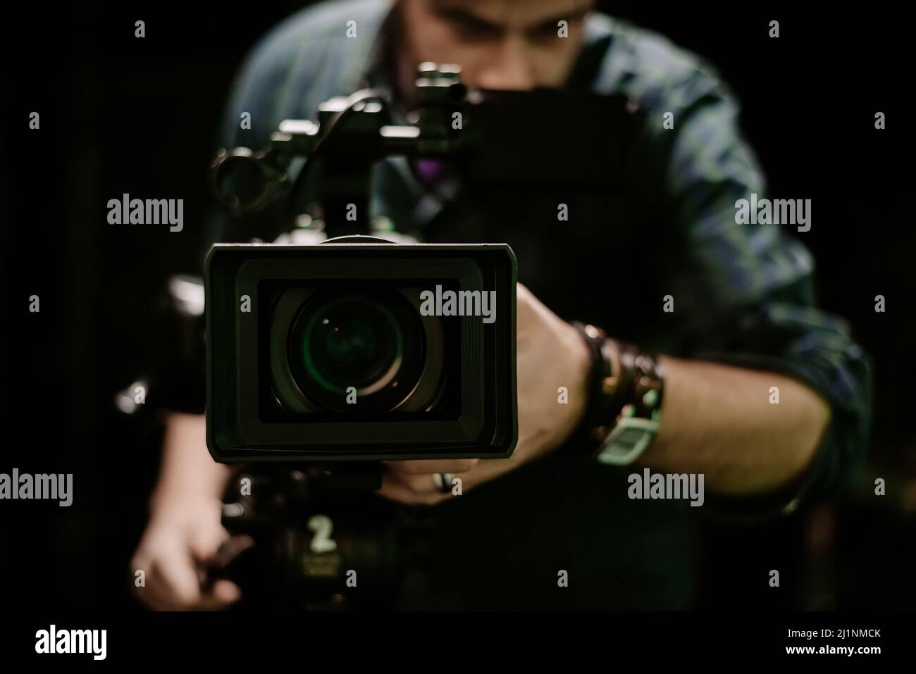 studio camera with man in the background recording Stock Photo - Alamy