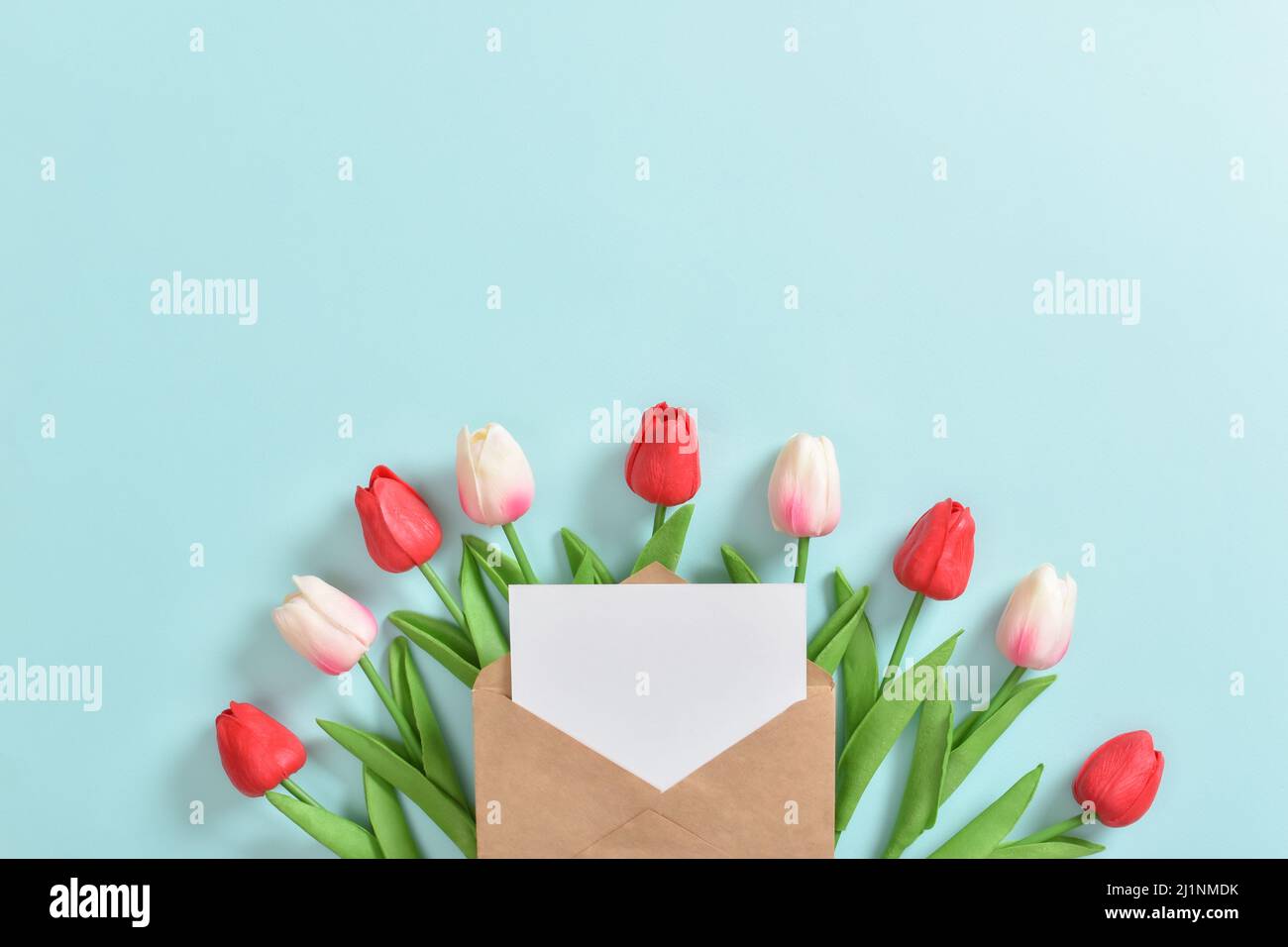 A festive banner with tulips and an envelope on a light blue background ...