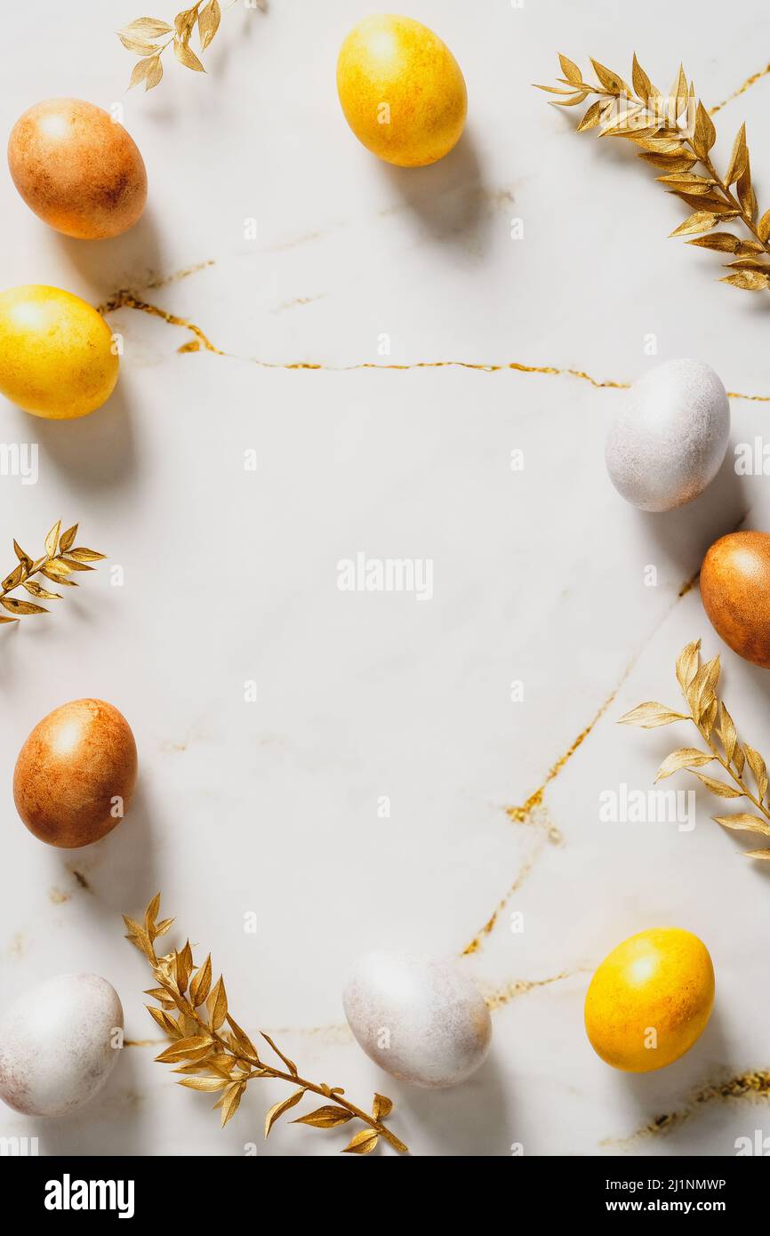 Happy Easter concept. Frame of luxury Easter eggs and golden branches ...