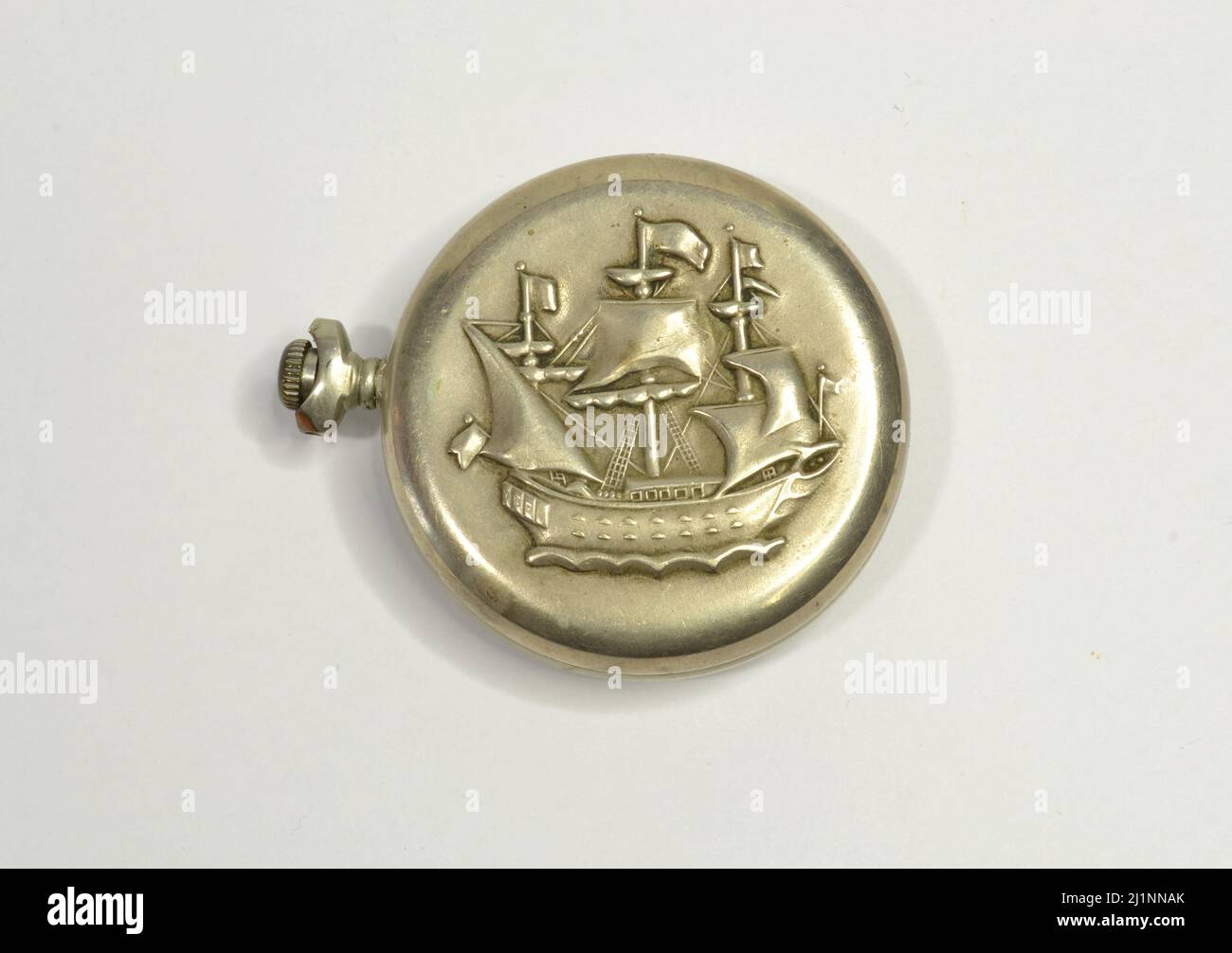 Back side of old pocket watch that shows Sailing ship Stock Photo - Alamy