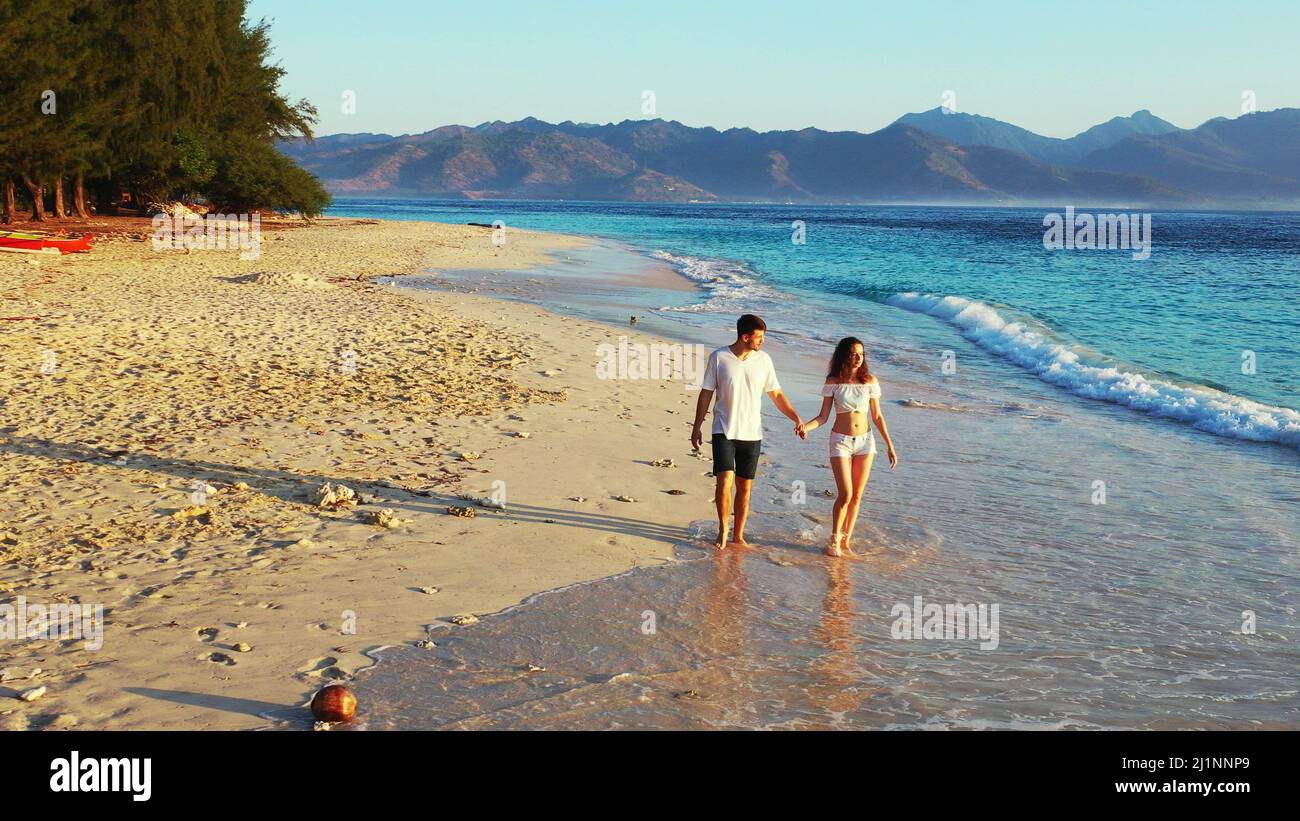 A beautiful caucasian couple enjoying time on the beach in Lombok ...