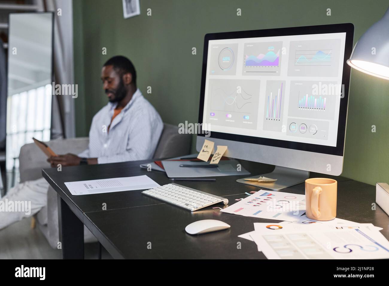 Background image of busy home office workplace with computer and person ...