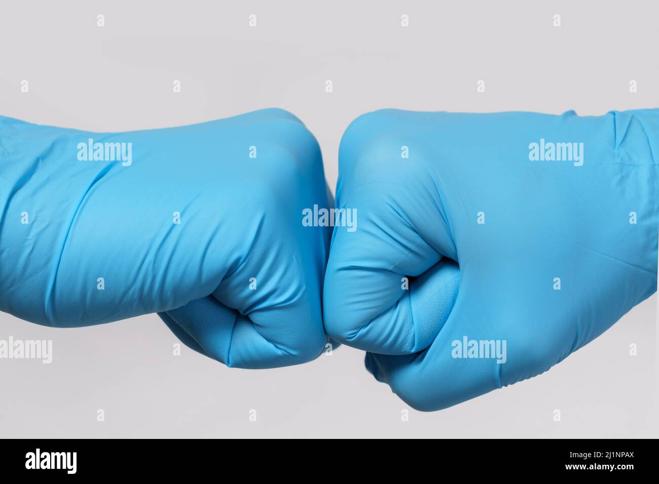 Two medical workers making a fist bump gesture Stock Photo - Alamy