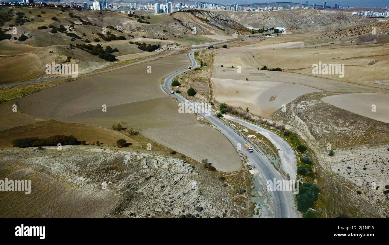Rural settlement and land. Empty farmland and cityscape in the distance ...