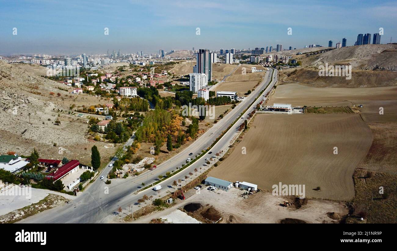Rural settlement and land. Empty farmland and cityscape in the distance ...