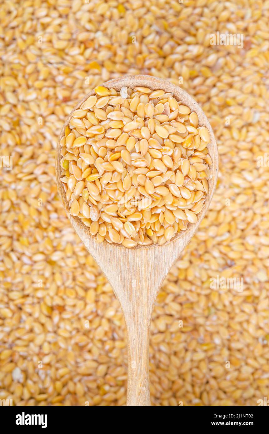 Gold flax seeds on a wooden spoon hi-res stock photography and images - Alamy