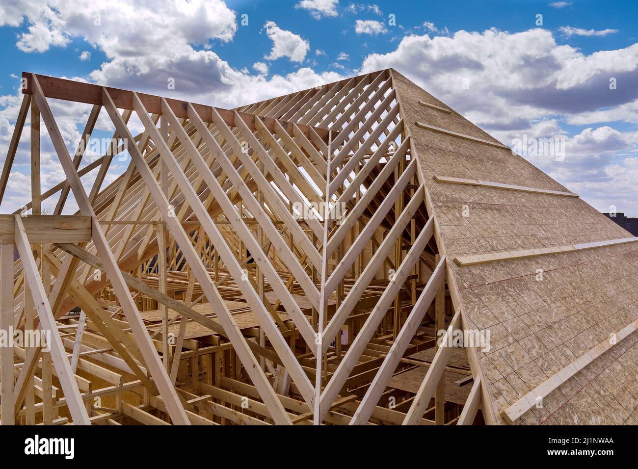 Panorama top view of closeup new wooden roof beams built home under ...