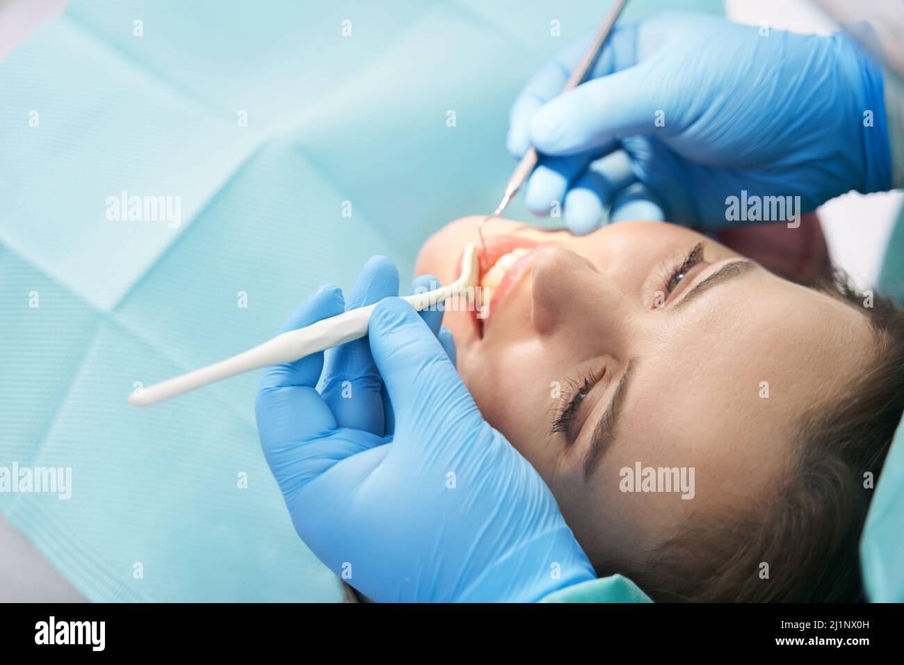 Dentist examining woman teeth in dental clinic Stock Photo - Alamy