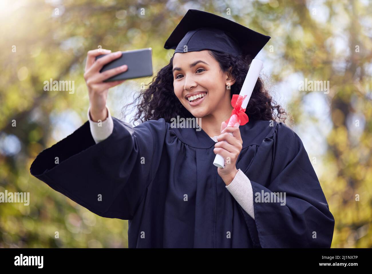 Learning looks good on you. Shot of a young woman taking a selfie on ...