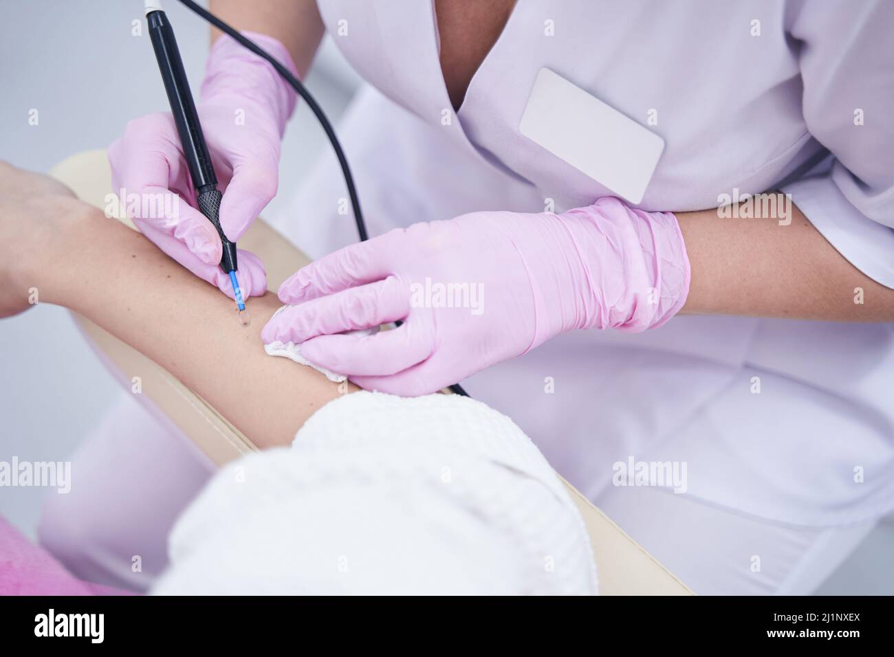 Female doctor cosmetologist removing hi-res stock photography and ...