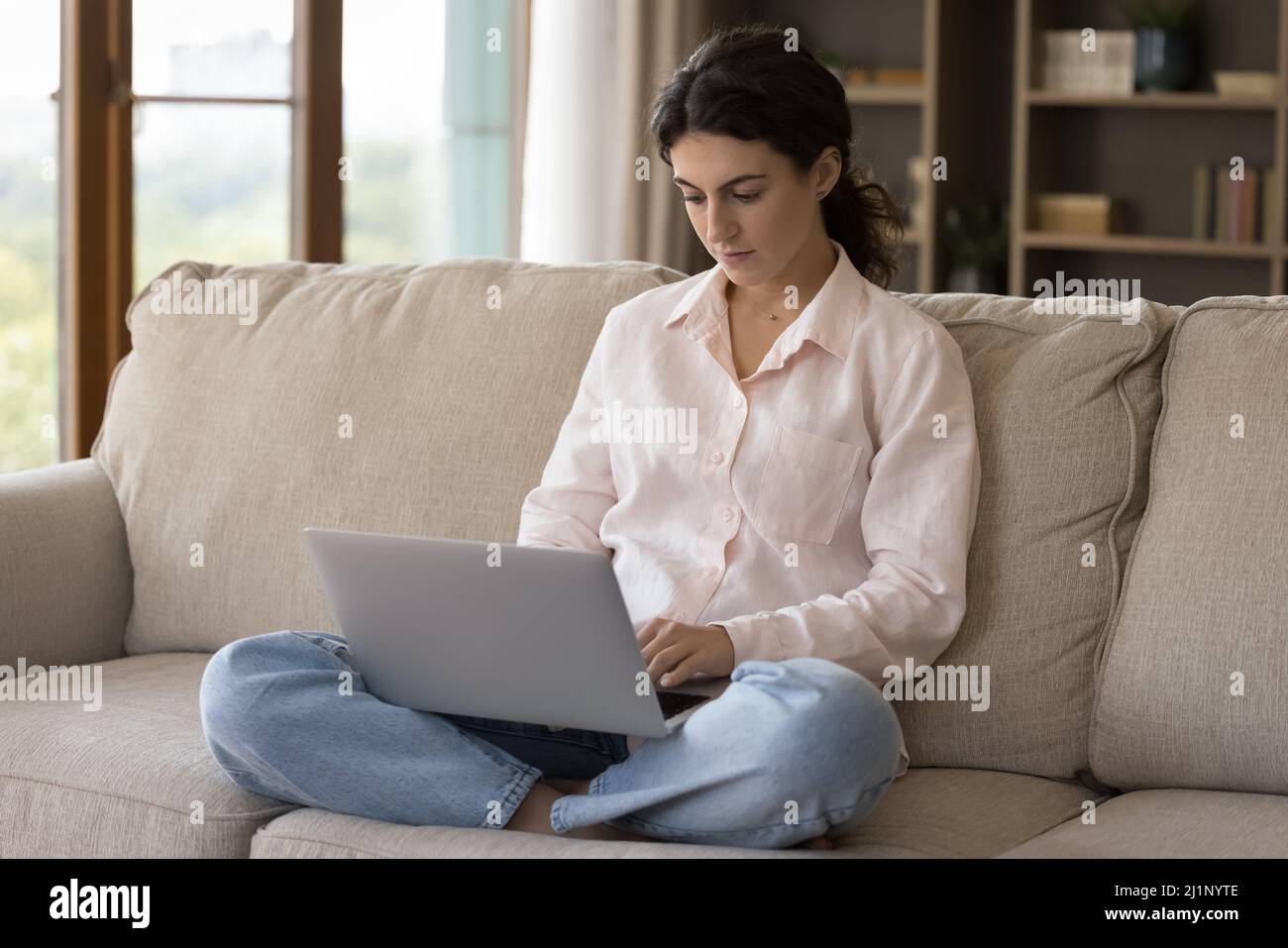 Serious student girl doing research study, using laptop computer Stock ...