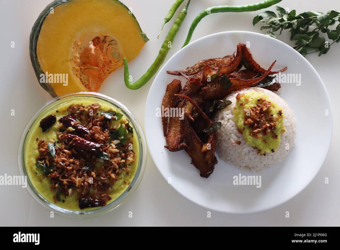 Kerala meals with boiled matta red rice, coconut based pumpkin curry ...