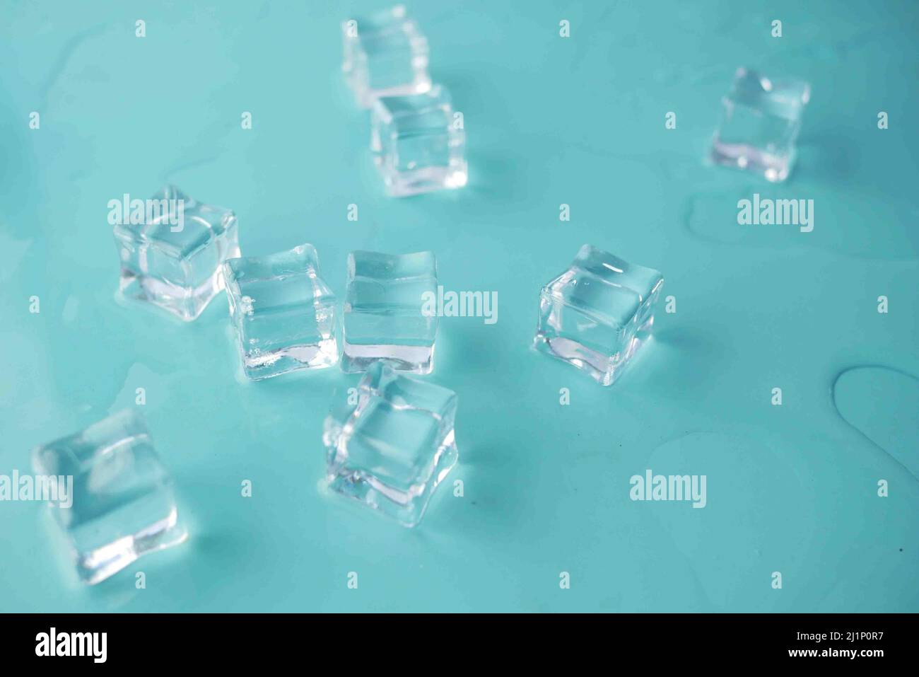 top view of many ice cubes on light green background Stock Photo - Alamy