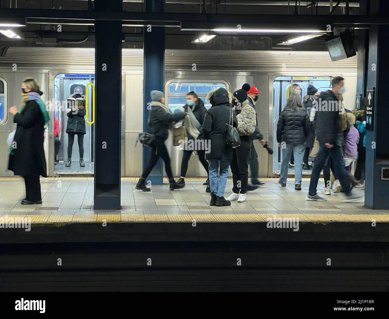 Riders on the Lexington subway line 6 train platform in Manhattan, New ...