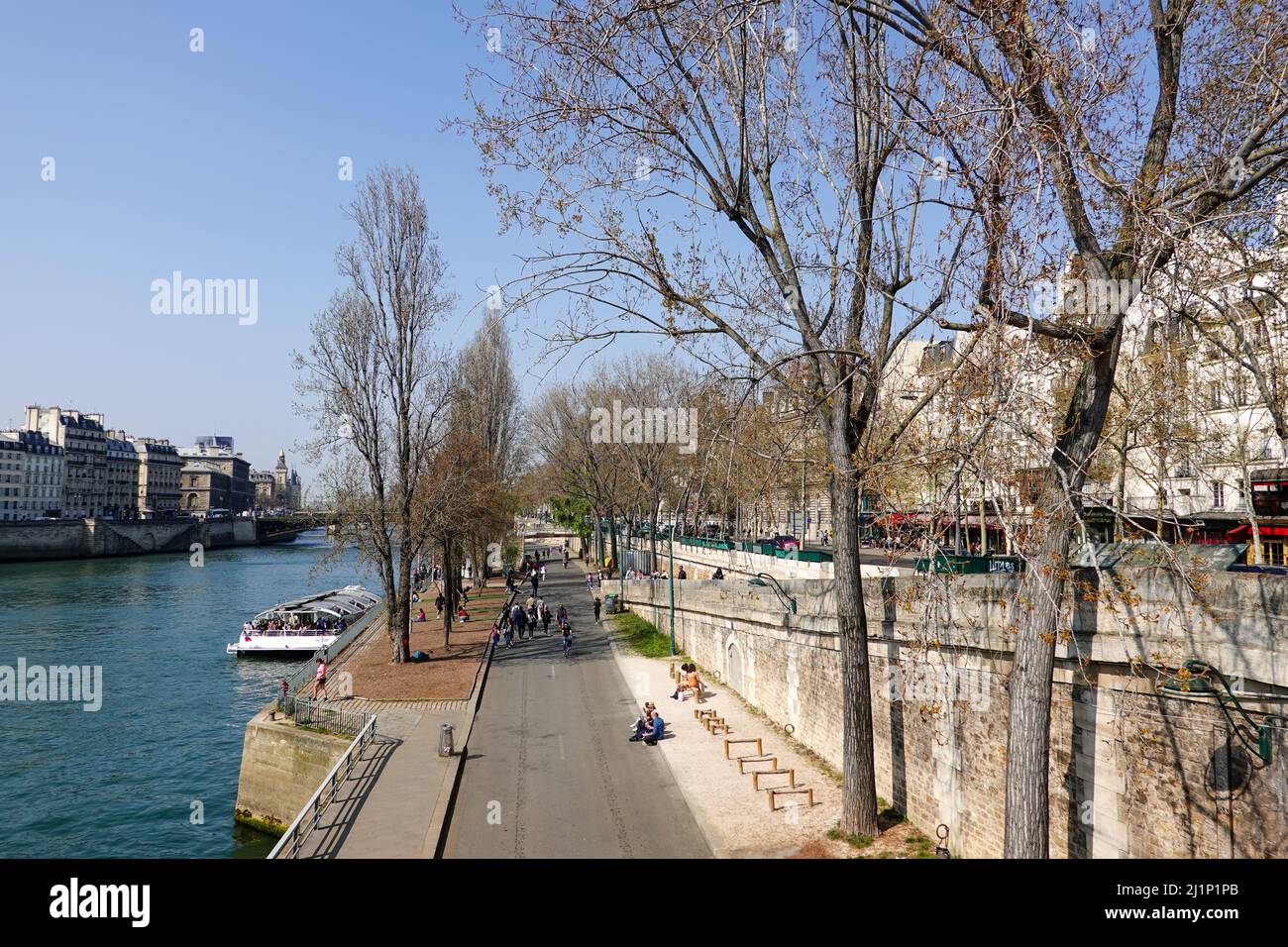 Pedestrians along the Rives de Seine as the Batobus arrives at its ...