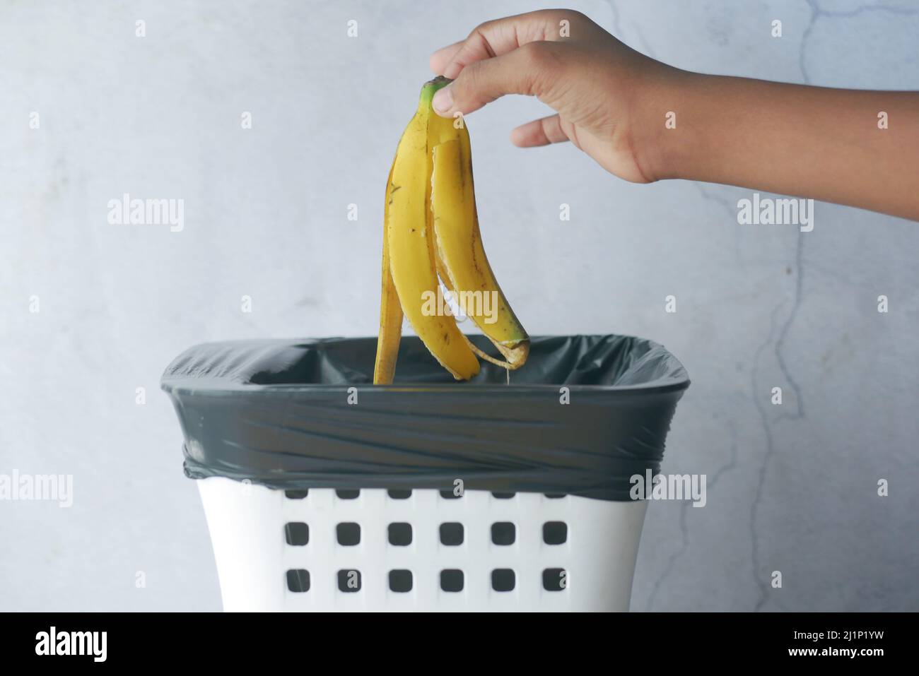 throwing banana in a garbage bin Stock Photo - Alamy