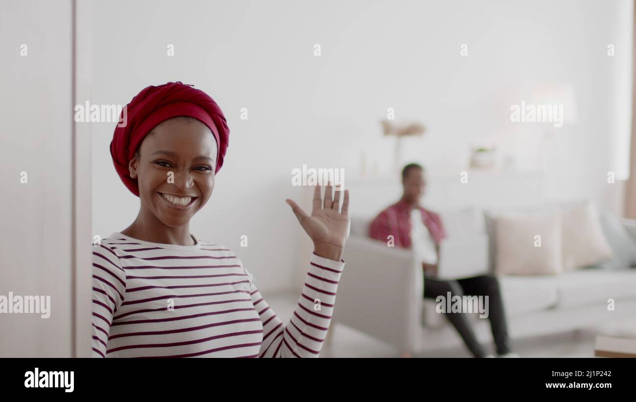 Black Woman Opening Door Waving Hello Calling Husband At Home Stock ...