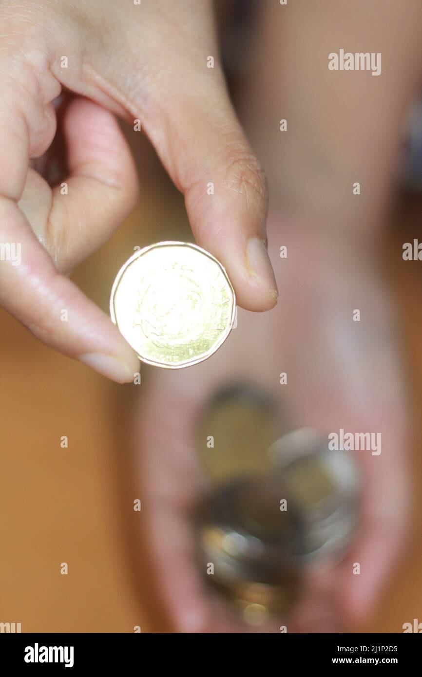 Women hold coin hi-res stock photography and images - Alamy