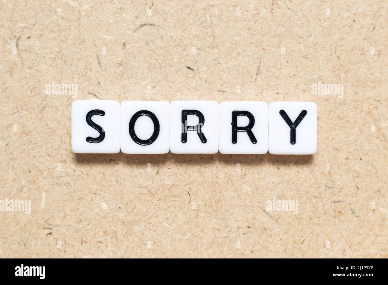 White tile alphabet letter with word sorry on wood background Stock ...