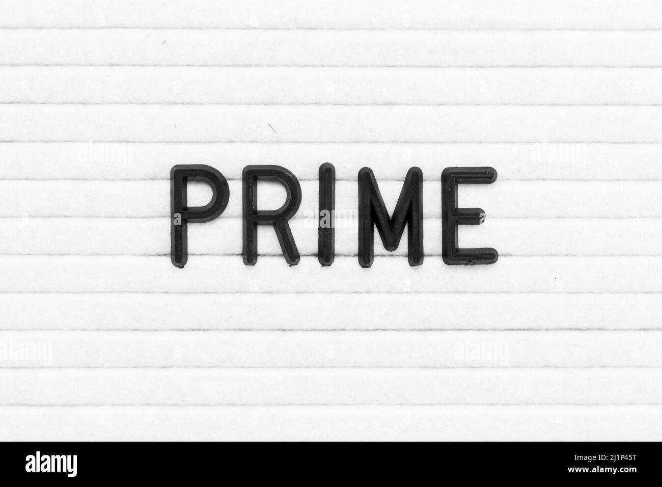 Black color letter in word prime on white felt board background Stock ...