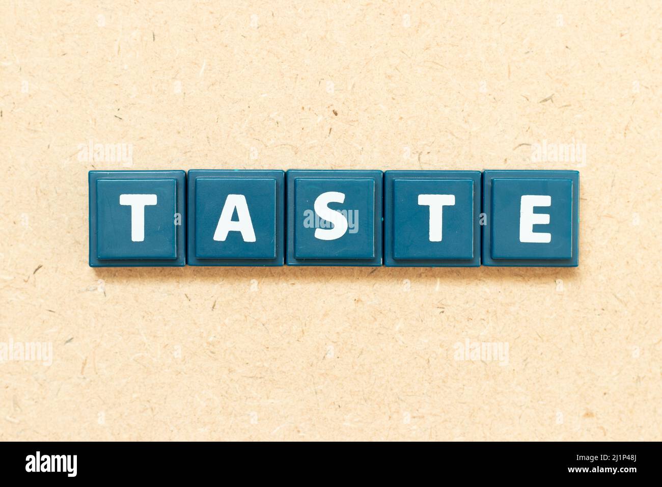 Tile alphabet letter in word taste on wood background Stock Photo - Alamy