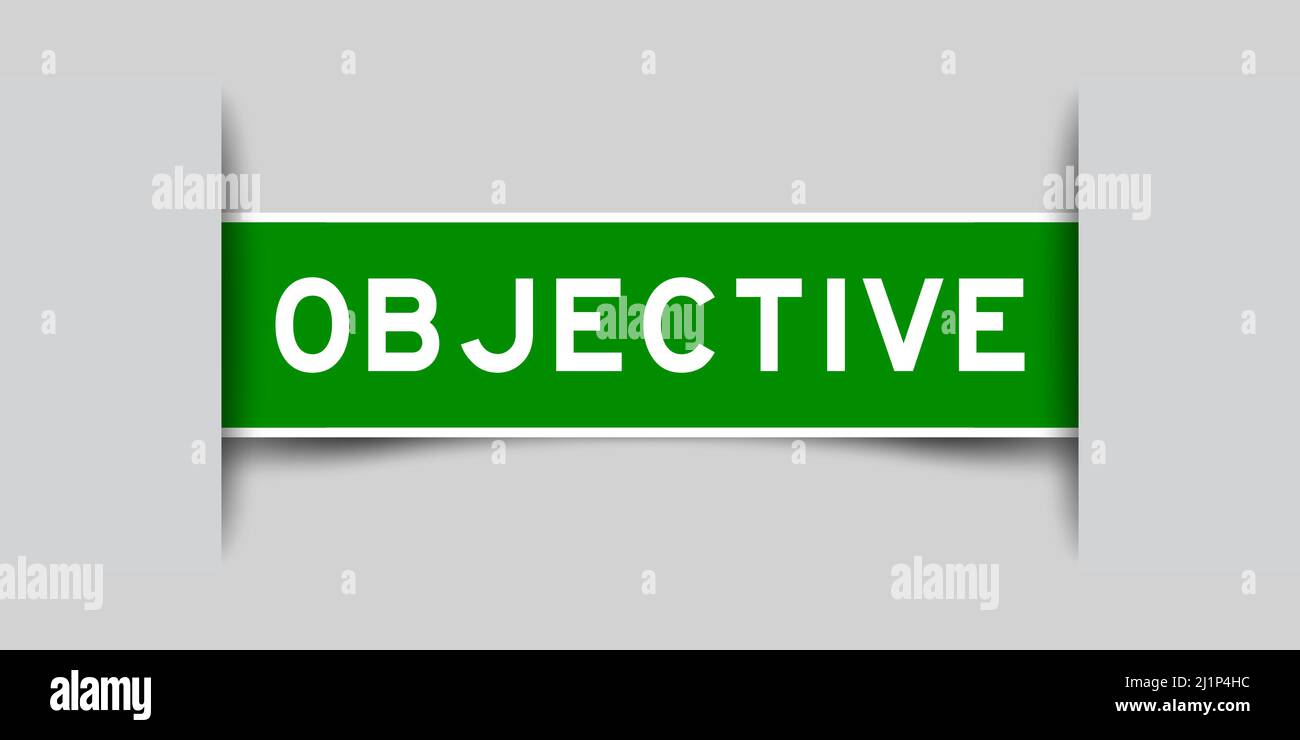 Inserted green color label sticker with word objective on gray ...