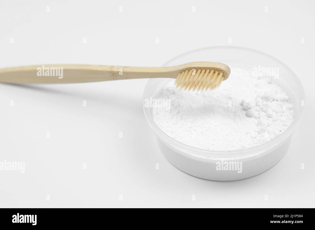 Bamboo toothbrush and tooth powder on a white background. Eco-friendly ...