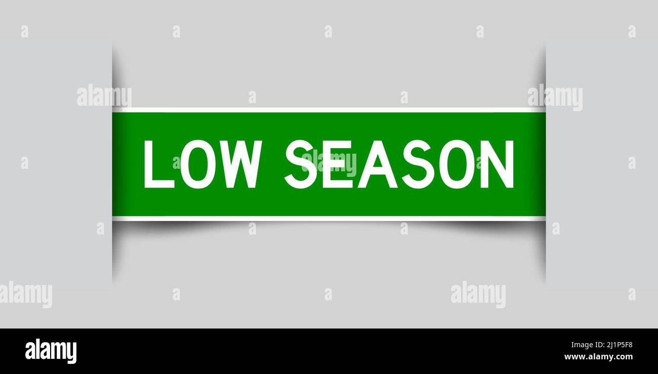 Inserted green color label sticker with word low season on gray ...