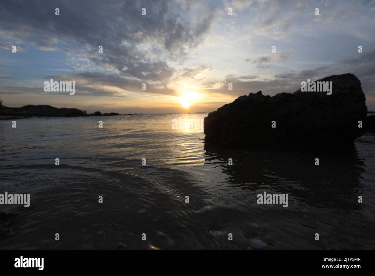 Man alone in the sea lonely feeling sunset time Stock Photo - Alamy