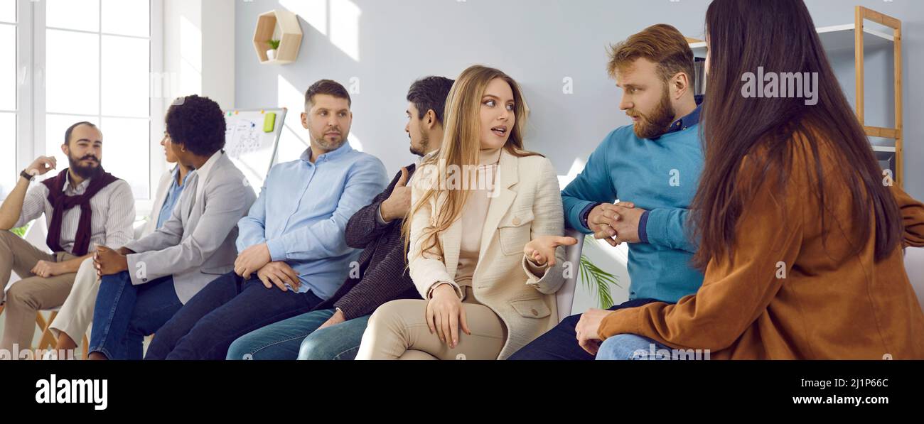 Multiethnic group of young people discussing something during business ...