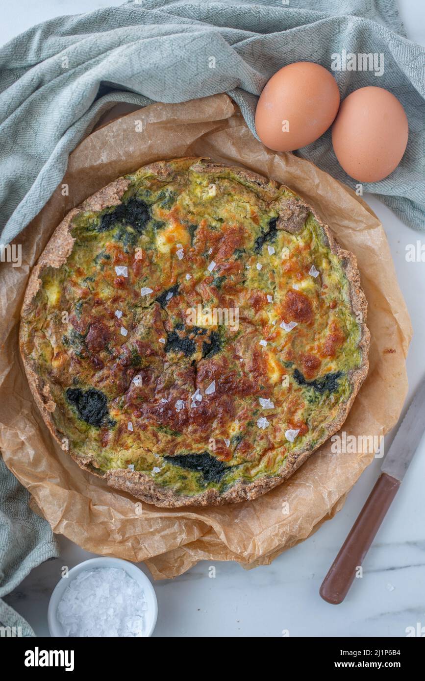 home made quiche with wild garlic on a table Stock Photo - Alamy