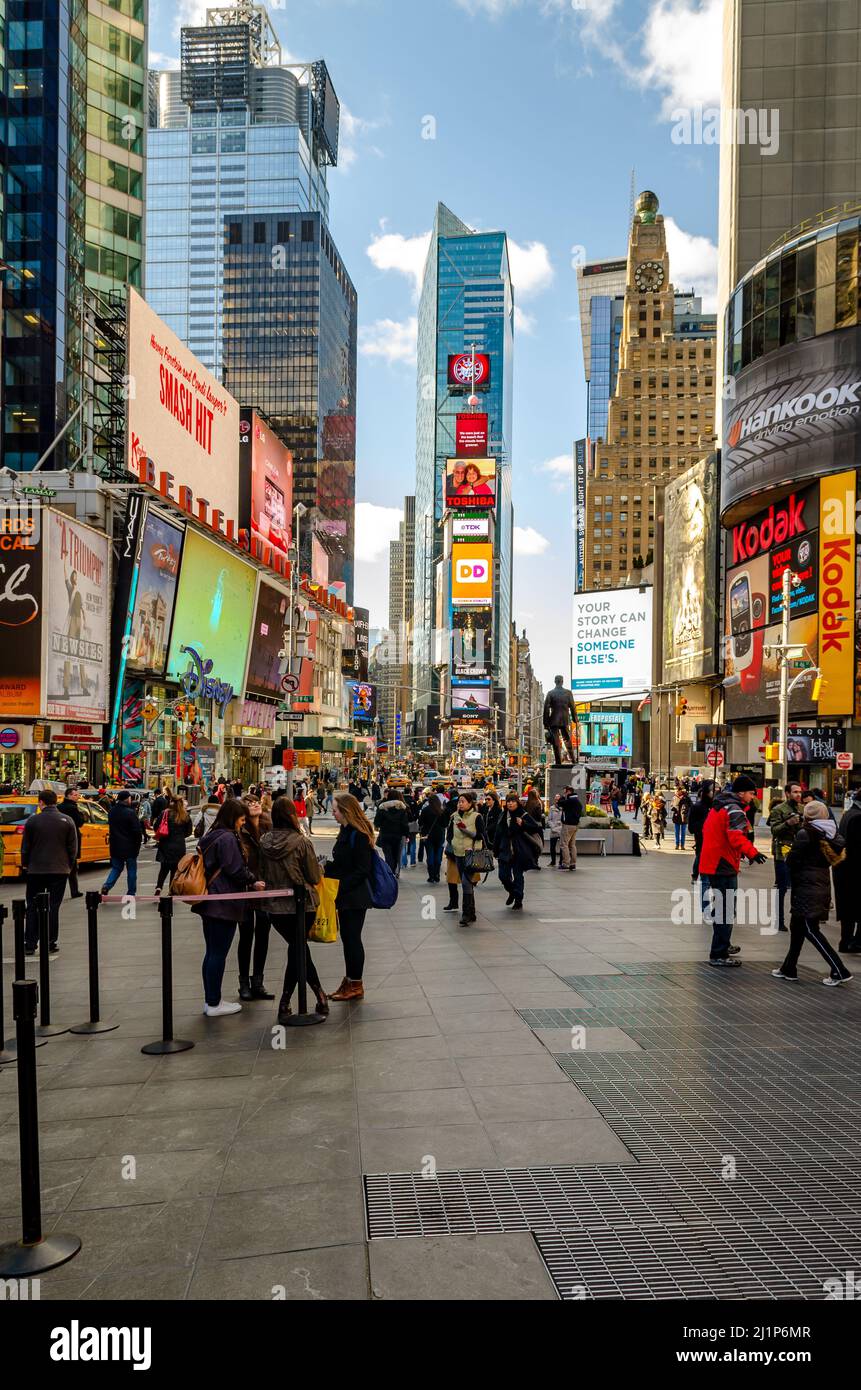 Crowded Time Square New York City with lots of People standing and ...