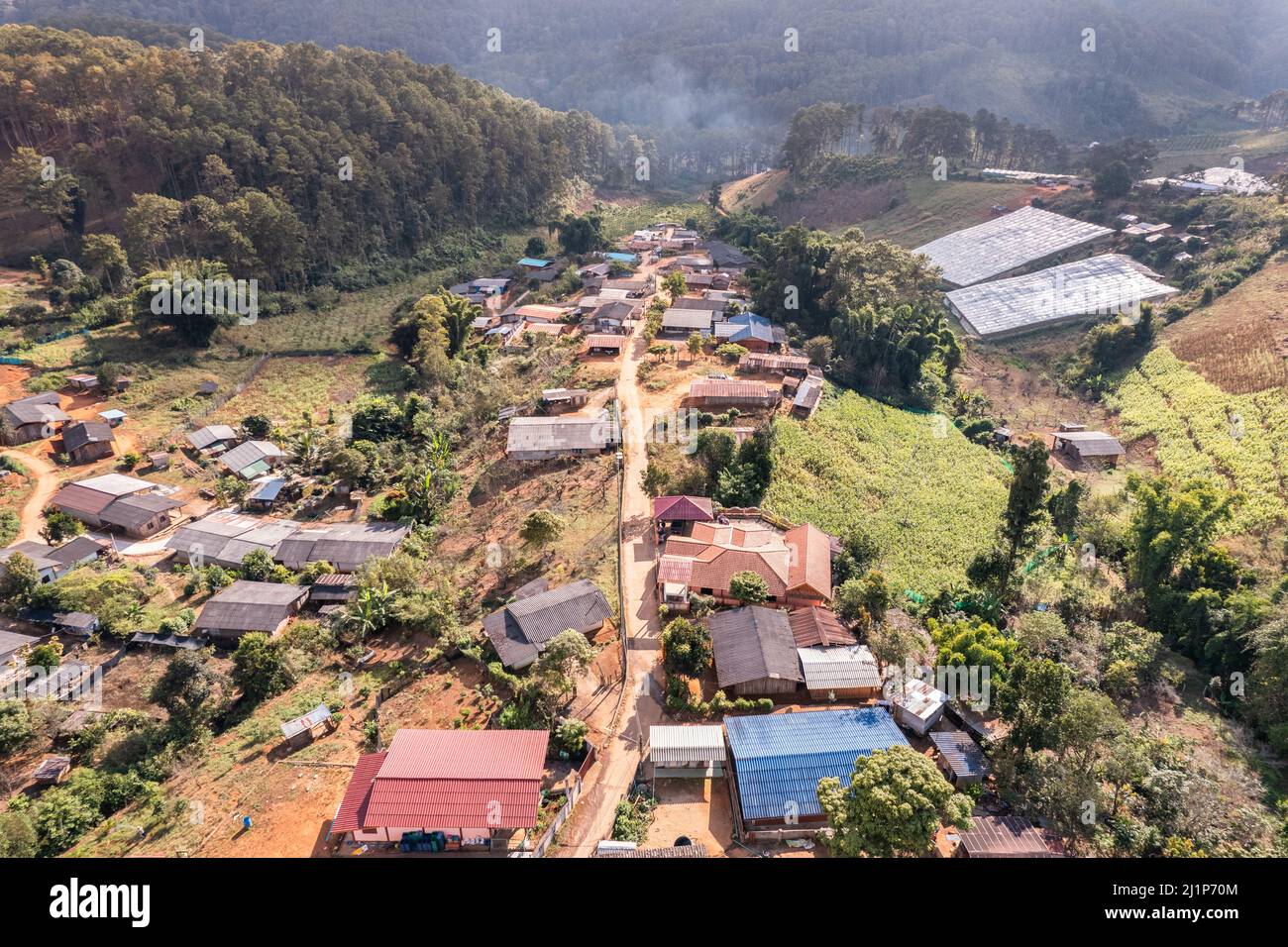 Aerial view of local rural village in the valley on faraway at ...