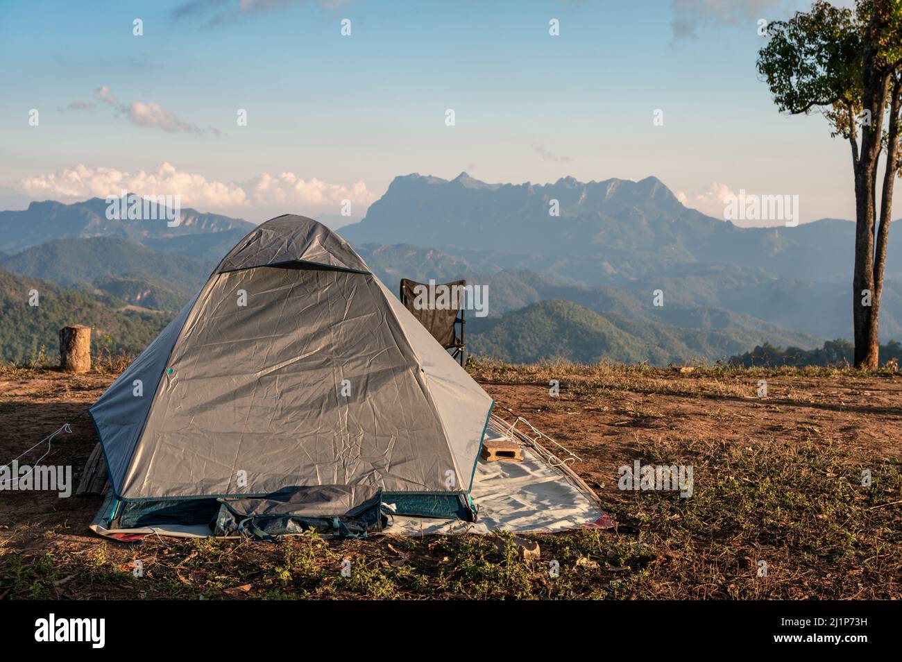 Tent camping on hill with mountain range in national park at evening ...