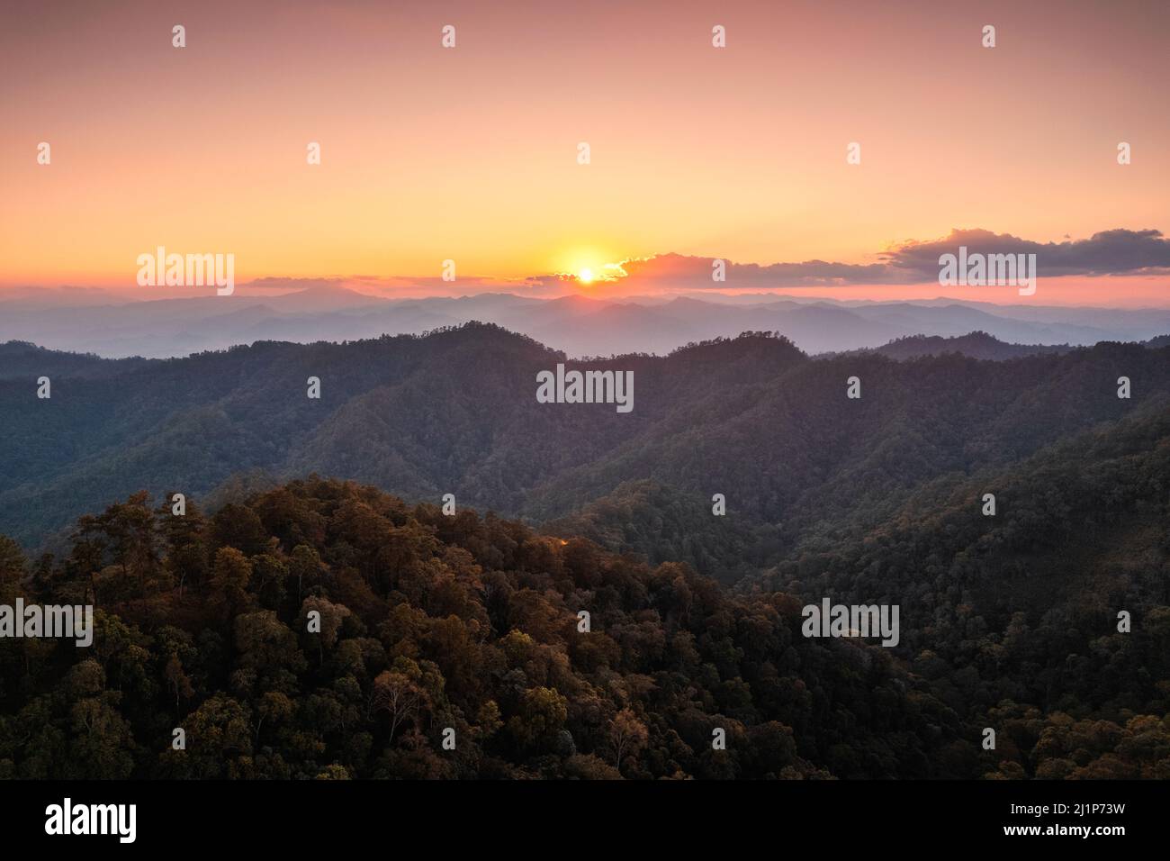 Aerial view of beautiful sunset over mountain range in tropical ...