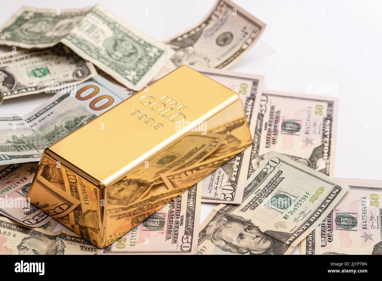 Expensive gold bar and US dollar bills Stock Photo - Alamy