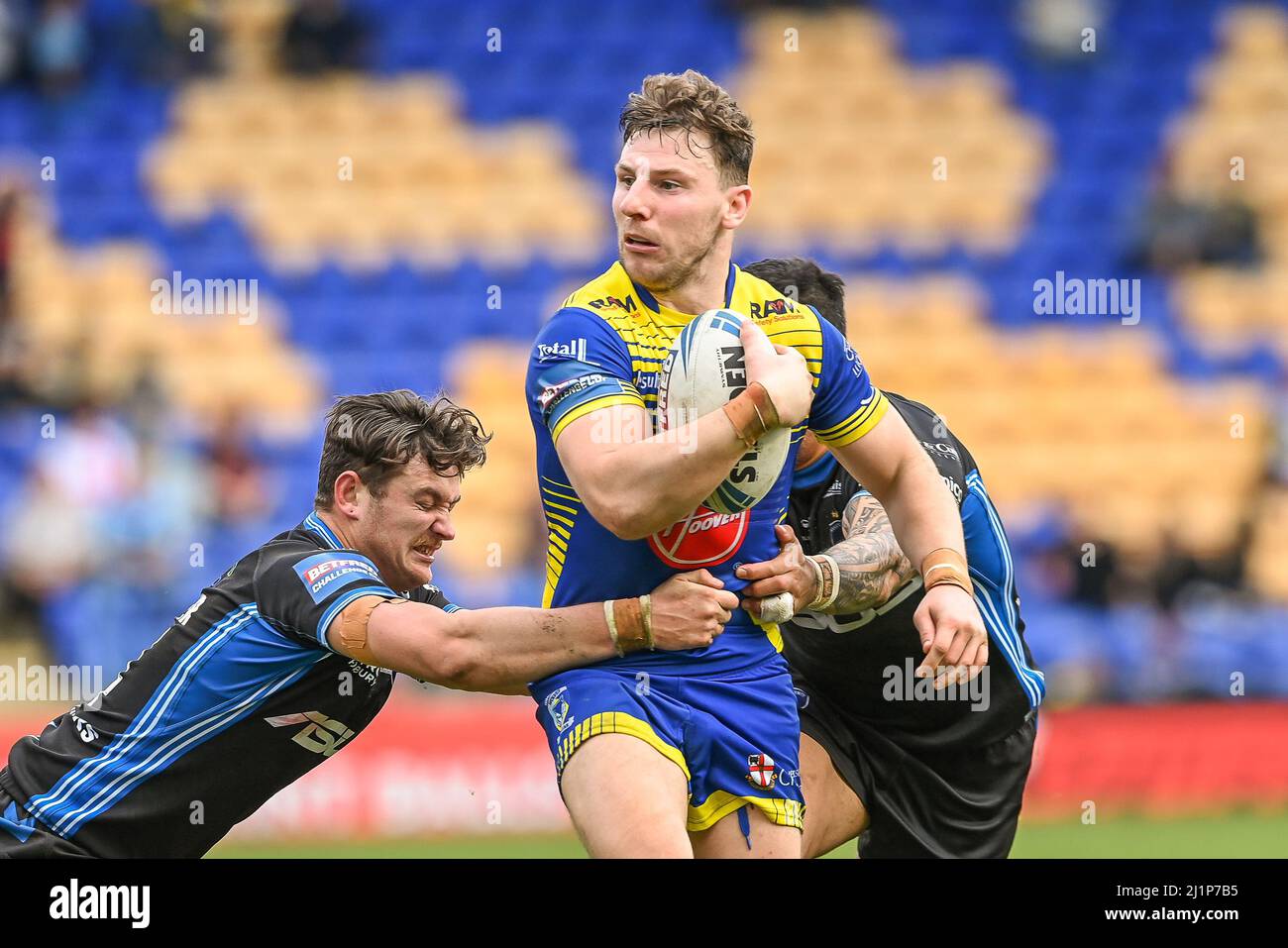 George Williams #7 of Warrington Wolves is tackled by Jordy Crowther ...