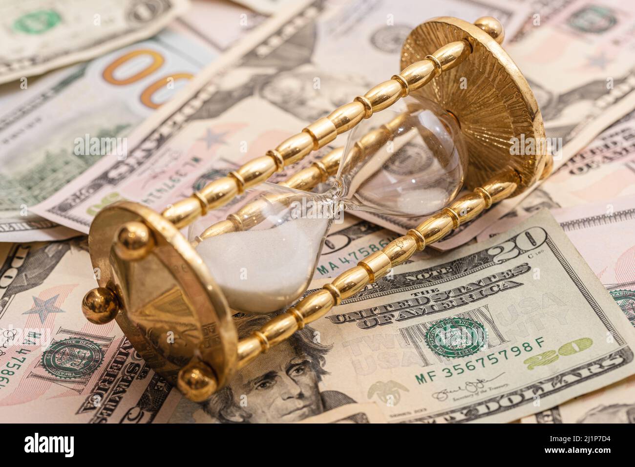 Hourglass and US dollar banknotes. Concept of investment and inflation ...