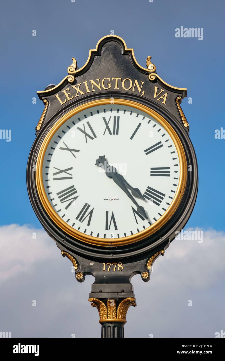 Antique clock on a post in Lexington Virginia, with blue sky and white ...