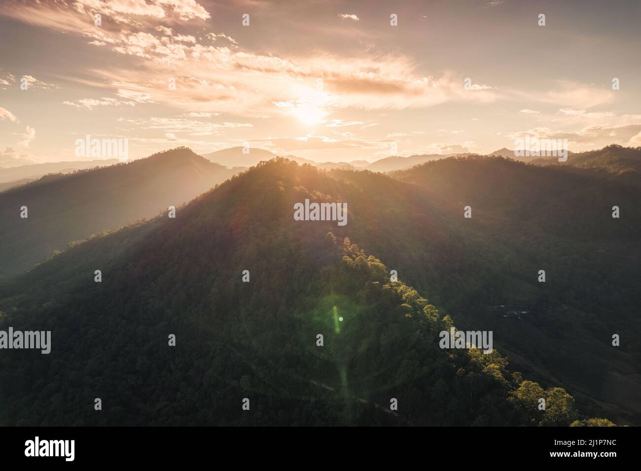 Aerial view of beautiful sunset over mountain range in tropical ...