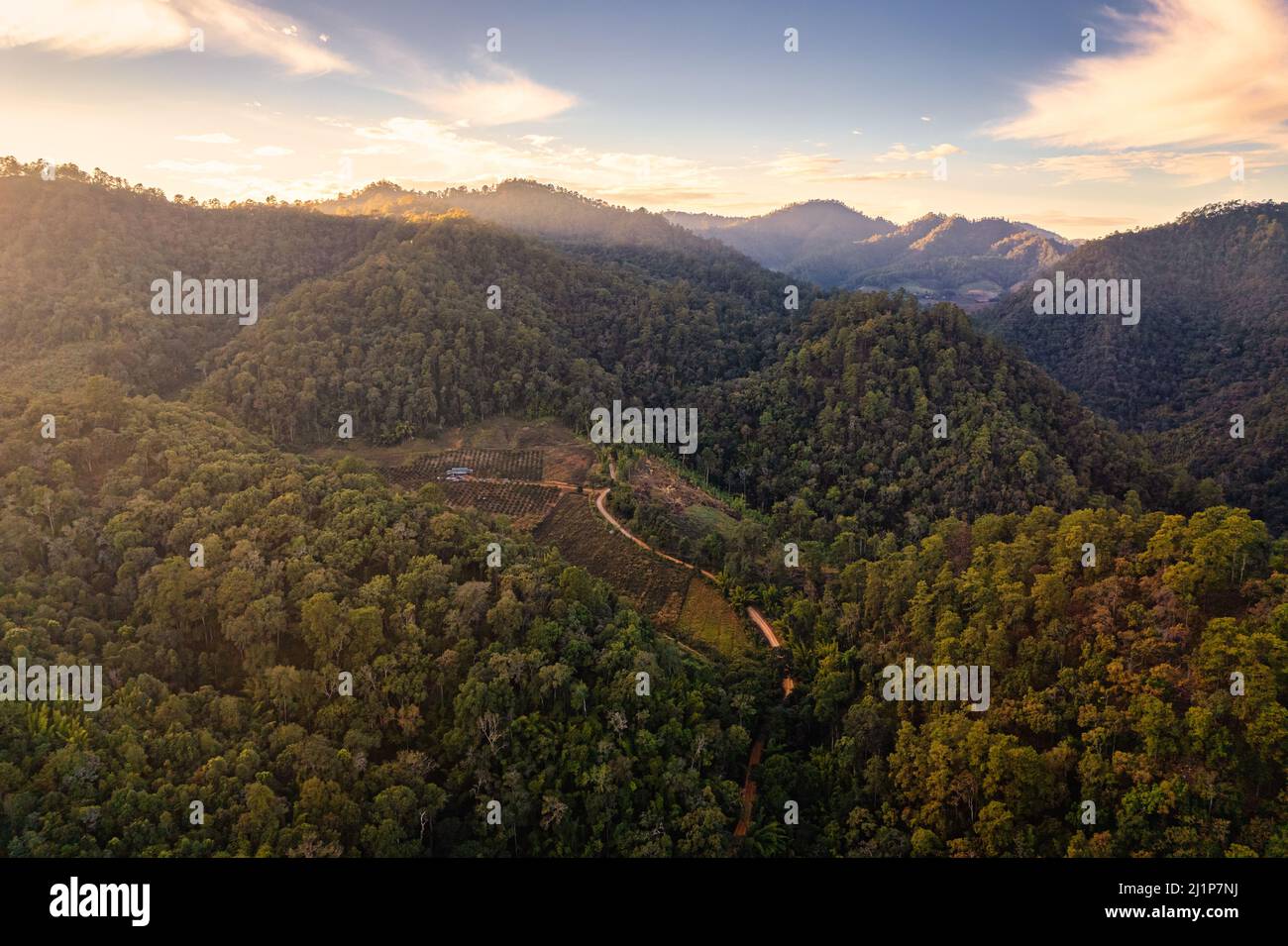 Aerial view of beautiful sunset over mountain range in tropical ...