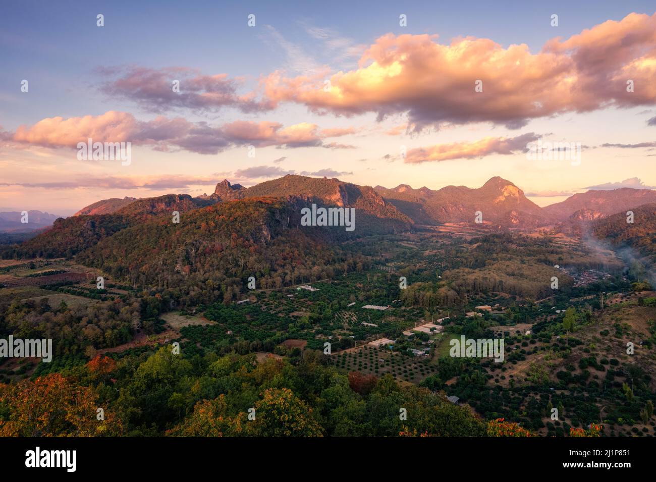 Aerial view of mountain range with colorful sky in tropical rainforest ...