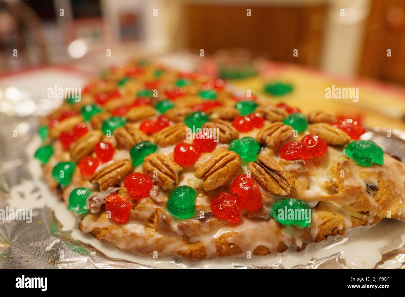 Homemade stollen with red and green candied cherries and pecans and ...