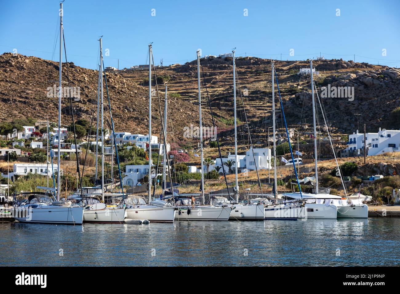 Luxury yacht, sailing boat moored at port dock of Mykonos Greek island ...