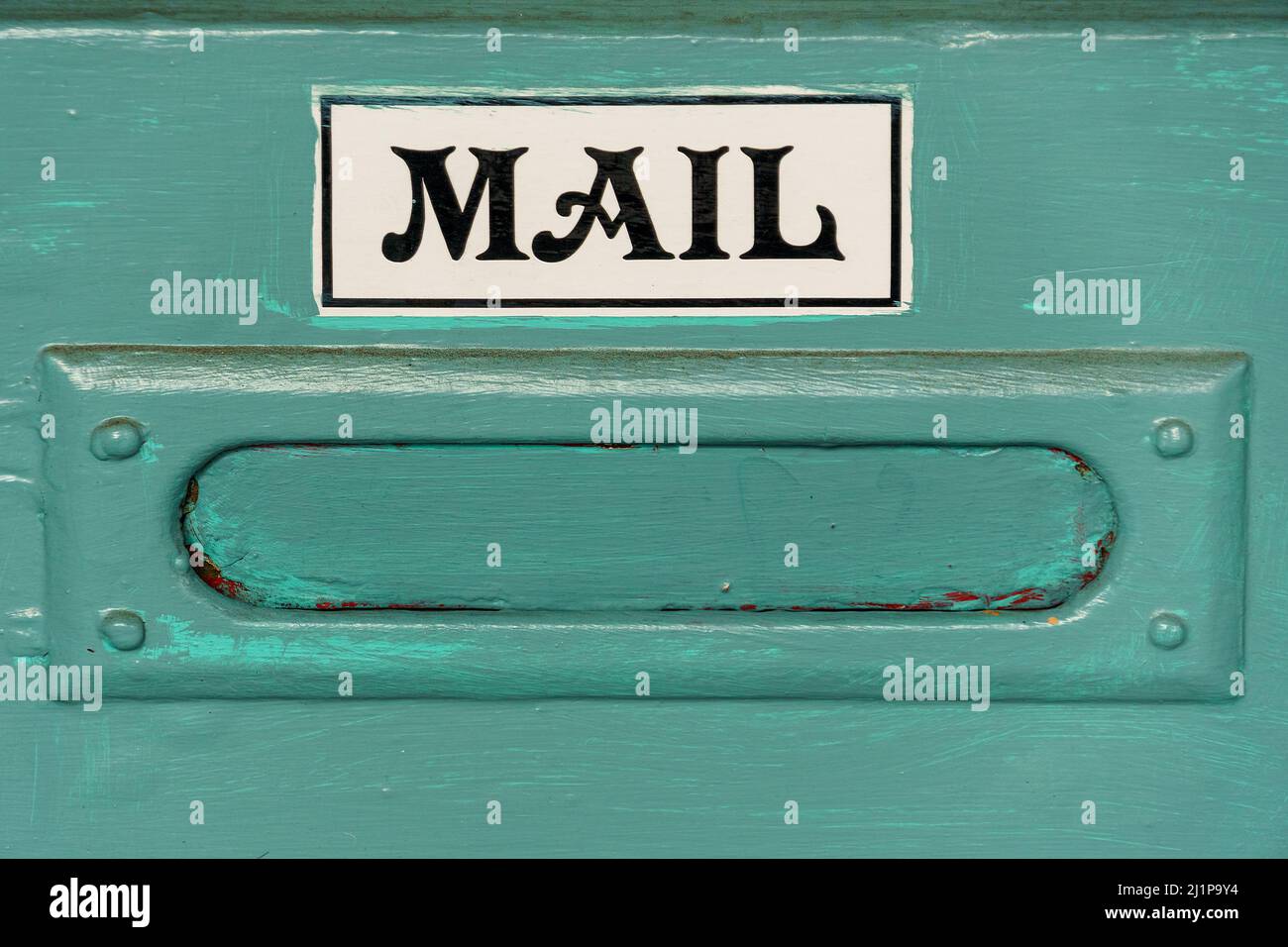 Vintage mail slot and sign in a blue door. Lettering is black on white ...