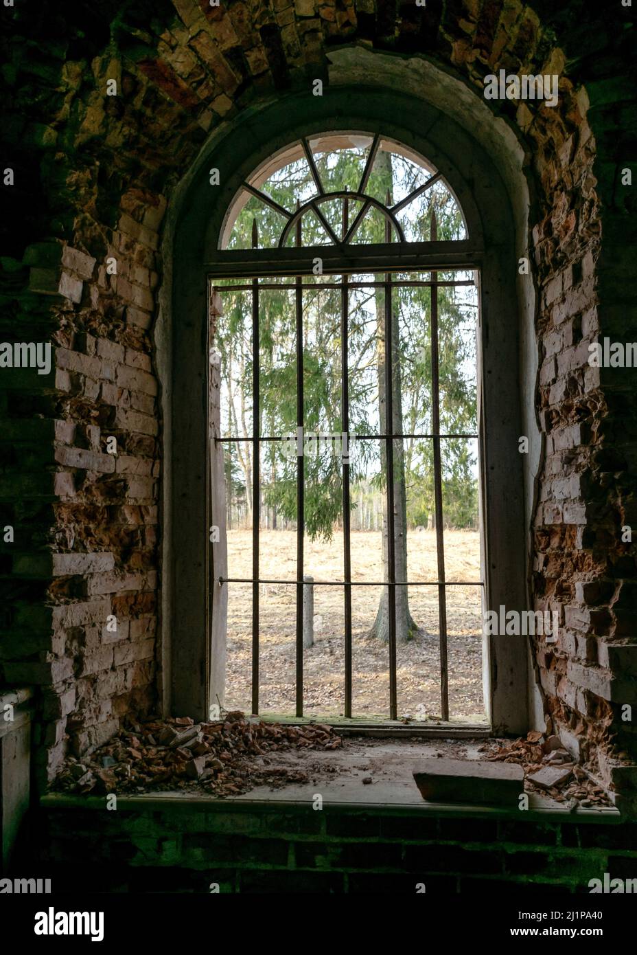 photo with old arched windows in an abandoned church, iron grilles in ...